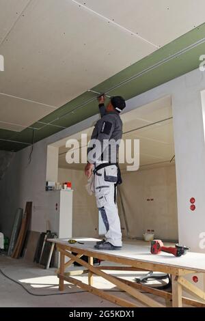 Man working on drywall construction Stock Photo - Alamy