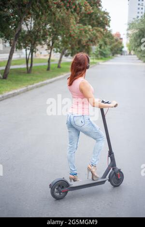 business woman listens to music in headphones on the background of the ...