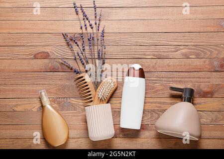 Composition with hair brush, comb and cosmetics on color background ...
