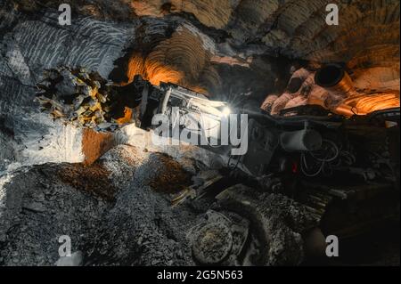 Underground mining of ore. Drilling head of a mine roadheader Stock ...