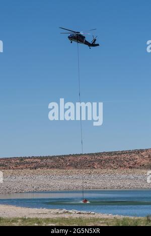 A Sikorsky UH-60 Blackhawk fire-fighting helicopter carries a ...