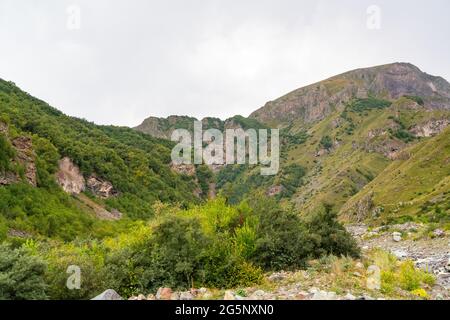A seething river against the backdrop of mountains and sky Stock Photo ...