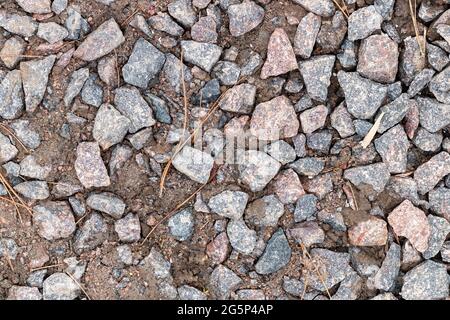 Wet moist ground with lots of granite stones. Natural gravel texture ...