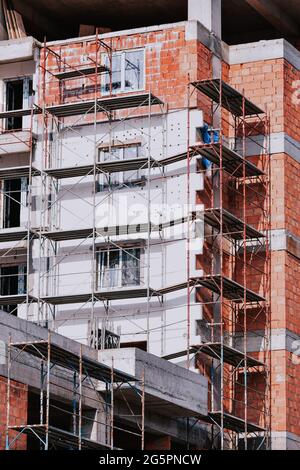 Unfinished concrete and red brick building project under construction ...