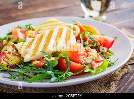 Grilled halloumi cheese salad with salt salmon, tomatoes and green ...