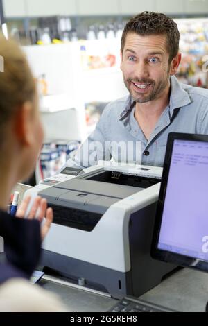 customer getting help at pay desk Stock Photo - Alamy