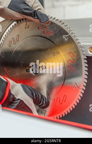 Saw disk circle install. The craftsman installs the circular saw blade ...