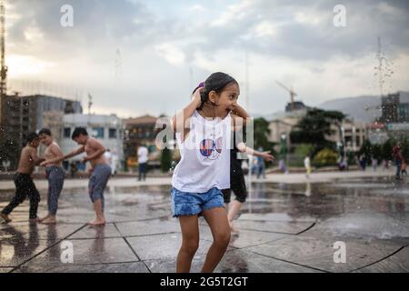 Tehran, Iran. 29th June, 2021. Children cool off at a splash pad during ...