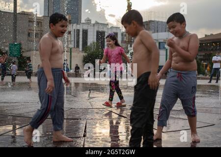 Tehran, Iran. 29th June, 2021. Children cool off at a splash pad during ...