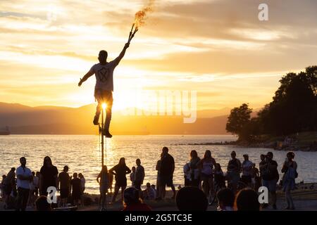 Talented Street Performer doing a show with a unicycle in front of a ...