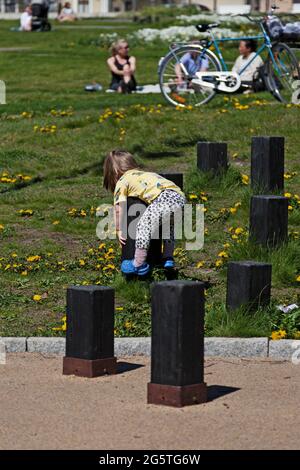 Child Girl climbs on a pole at the playground, sliding, kid playing ...