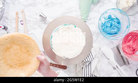 Stacking cake layers to create the round three-layer vanilla cake Stock ...