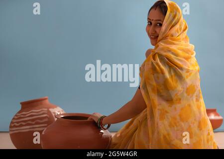 A woman sitting with matkis Stock Photo - Alamy