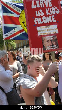 A demonstrator holds up a placard reading 'From river to the sea, free ...