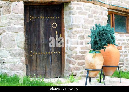 A woman in front of an authentic Anatolian house door Stock Photo - Alamy