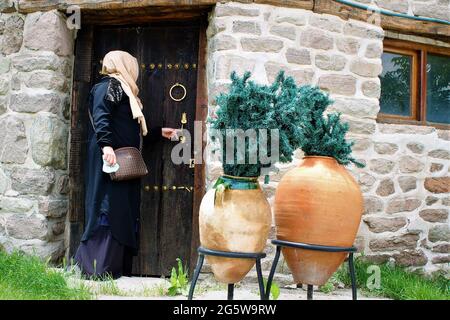 A woman in front of an authentic Anatolian house door Stock Photo - Alamy