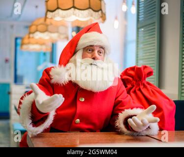 Friendly santa claus in a cafe Stock Photo - Alamy