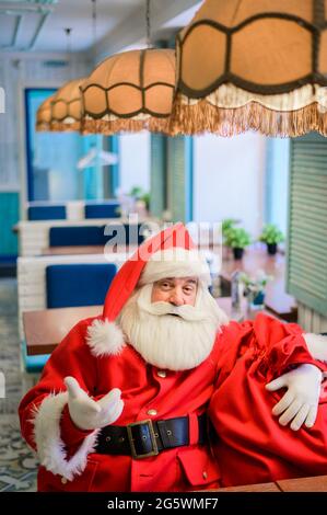 Friendly santa claus in a cafe Stock Photo - Alamy