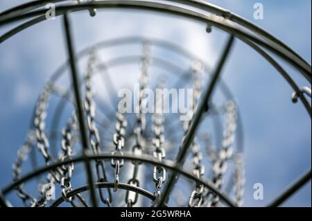 Underneath a disc golf goal looking up with selective focus on the ...
