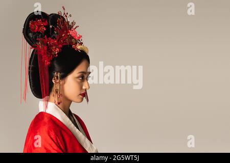 Side view of a pretty Japanese kimono woman standing isolated over ...