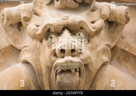 Close up of grotesque, scary face of statue of Balinese demon with ...
