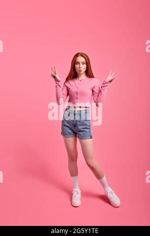 Full length photo of excited lucky man wear green t-shirt rising fists ...