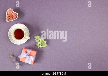 Gift box, flowers and a cup of tea in bed, top view Stock Photo - Alamy