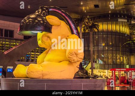 31.05.2021, Doha, Qatar: Yellow lamp teddy bear sculpture in the middle ...