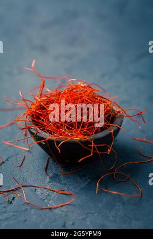 Red thin hot chili threads on a dark background. For decorating Asian ...