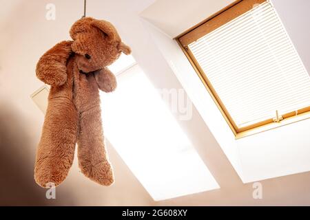 A teddy bear hanging in a noose in the attic room Stock Photo - Alamy