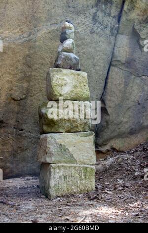 A stack of rocks is arranged in a pyramid shape. The rocks are of ...