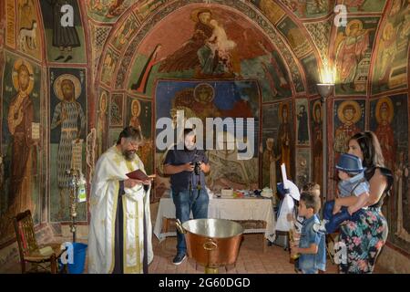 Nikitari, Cyprus - 17 May 2021: people during a baptism on the church ...
