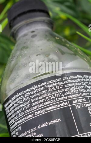 Shot of zero sugar Pepsi Max soft drink bottle in hedgerow with ...