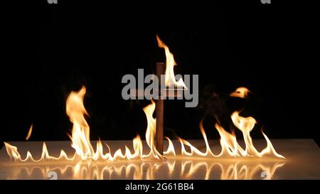 Fire around a burning cross symbol Stock Photo - Alamy