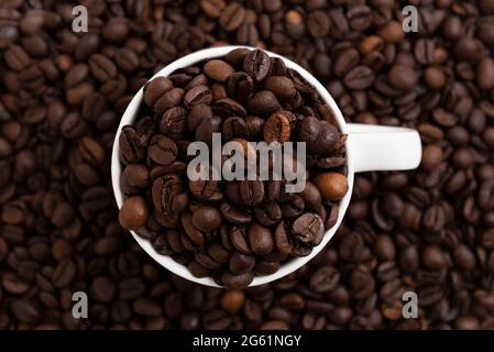 Coffee mug fulled of coffee beans top view Stock Photo - Alamy