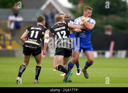 Leeds Rhinos' Tom Holroyd (right) is tackled by St Helens' James Bell ...