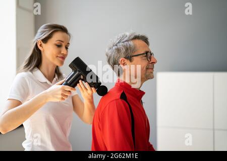 Massage Gun Shoulders Recovery Therapy Using Machine Stock Photo - Alamy