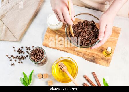 Woman mixing ingredients preparing coffee scrub or mask for skin ...