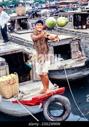 Man unloading fruit and vegetables from plastic crates to display in ...