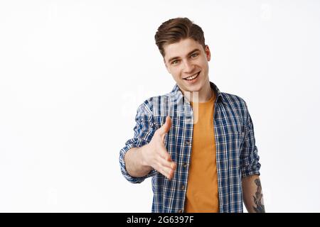 Friendly nice guy extend hand for handshake, greeting you and smiling ...