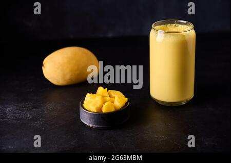 Mango Lassi, smoothie bowl with turmeric. Fresh tropical fruit on a ...