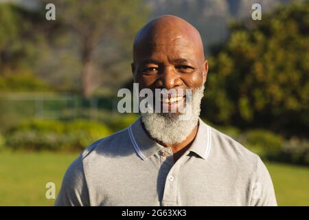 Portrait of smiling senior african american man in stunning countryside ...