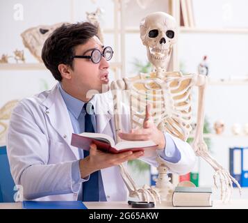 Crazy professor studying human skeleton Stock Photo - Alamy
