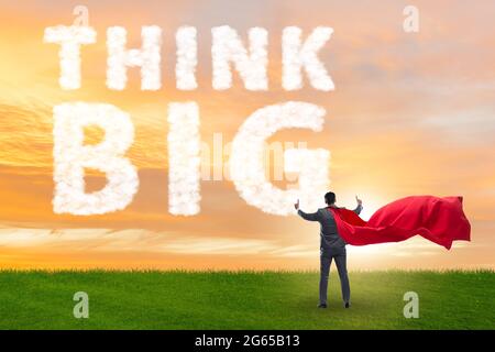 Think big concept with businessman superhero Stock Photo - Alamy