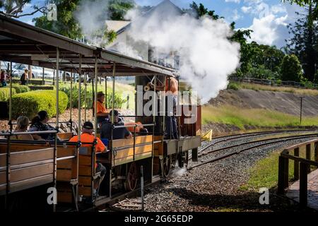 Tourists riding on the Mary Ann replica steam locomotive in Maryborough ...