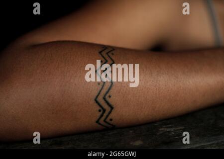 A woman showing her tattoo at the traditional longhouse of Dayak Iban ...