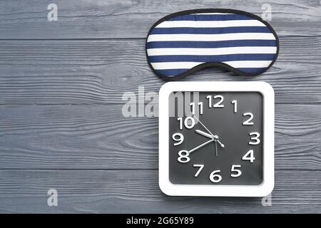 Stylish sleeping mask on wooden table in bedroom Stock Photo - Alamy
