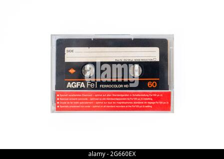 Red AGFA audio cassette, retro audio technology, on white background ...