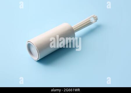 Lint roller on color background Stock Photo - Alamy