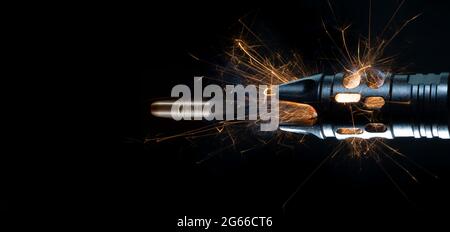 Copper bullet after leaving the barrel of an assault rifle with sparks ...